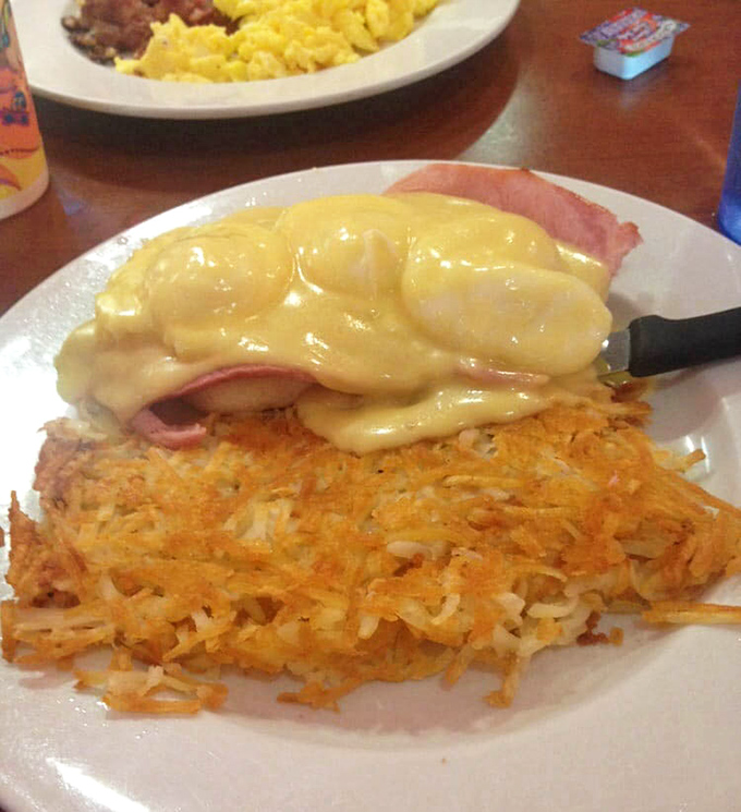 Eggs Benedict reimagined with those impossibly crispy hashbrowns &ndash; breakfast architecture that deserves its own HGTV special.