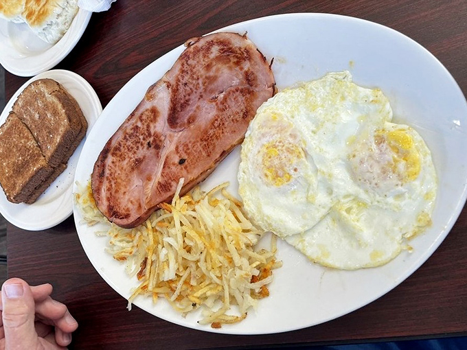 The classic breakfast trinity &ndash; perfectly cooked eggs, ham with just the right sear, and hash browns crisped to golden perfection.