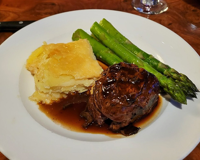 This perfectly cooked filet mignon with asparagus and potatoes represents steakhouse excellence at its finest.