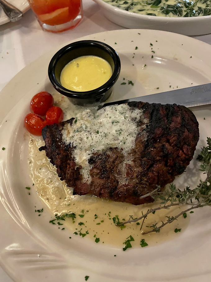 A steak so perfectly cooked it deserves its own Instagram account. That melting pat of herb butter is just showing off.