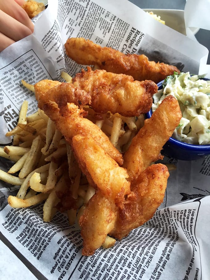 Golden-battered fish stands at attention alongside crispy fries and creamy slaw &ndash; the holy trinity of comfort food that transcends geographical boundaries.