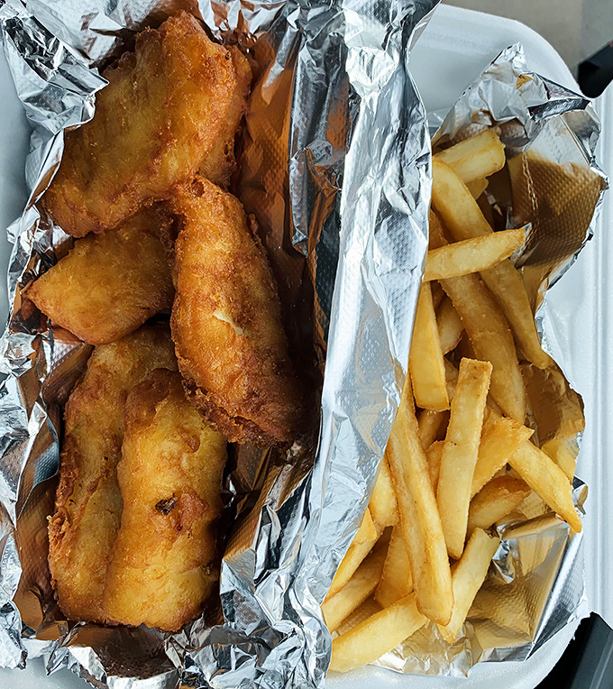 Golden-battered fish and crispy fries that would make a British pub jealous, served in unpretentious foil that keeps everything perfectly hot.
