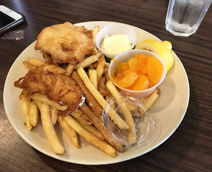 Golden-battered fish and chips with a side of sunshine-bright oranges. The perfect balance of indulgence and "see, I ate fruit too!"