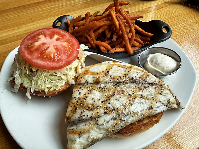 Fish sandwiches elsewhere are sad, frozen affairs. This one looks like it just had a spa day before meeting its destiny on artisanal bread.