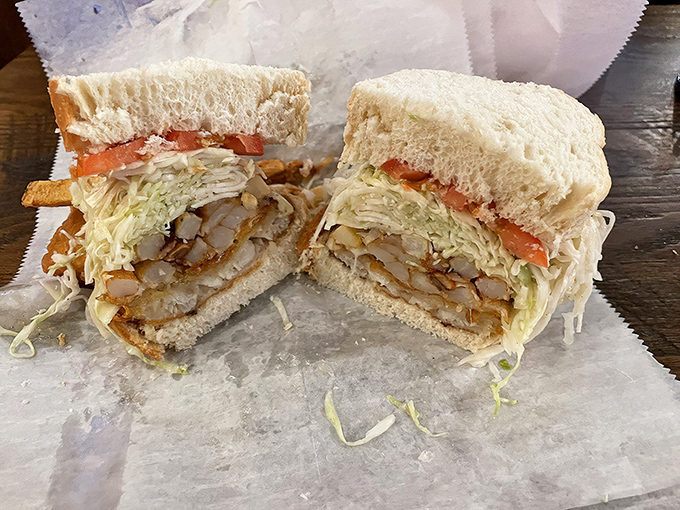 Two halves that make a whole lot of sense. This fish sandwich cross-section reveals the brilliant stratification of Primanti&rsquo;s engineering marvel.