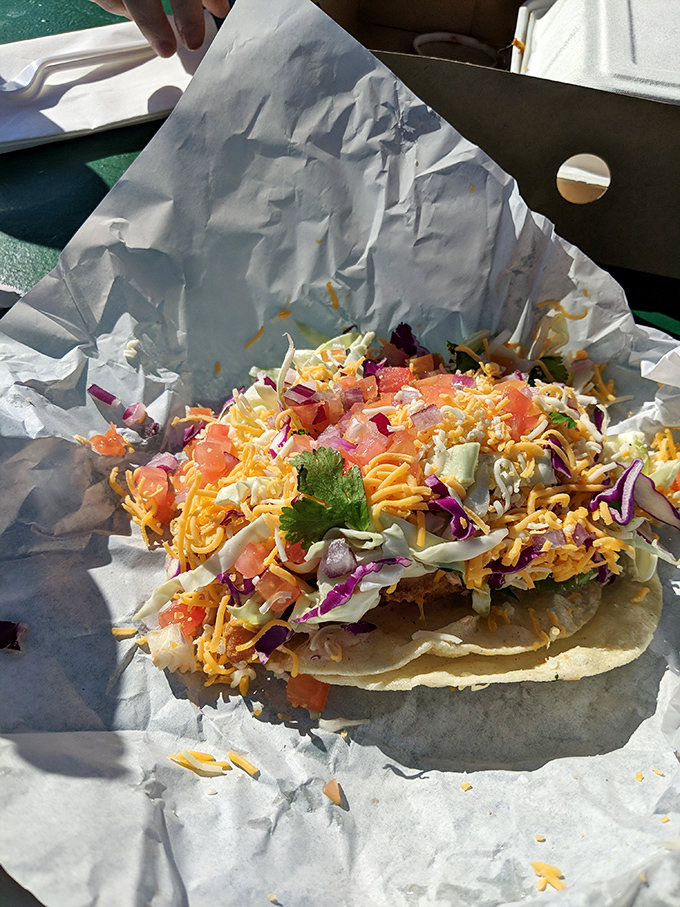A rainbow of fresh ingredients transforms this simple taco into edible art&mdash;purple cabbage, yellow cheese, and green cilantro creating a fiesta for your taste buds.