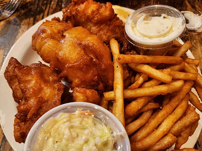 Golden-battered fish that shatters with each bite, paired with fries so perfectly crisp they deserve their own fan club.