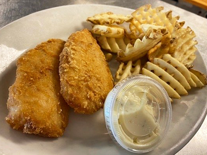 The fish and chips arrive with waffle fries that look like they're wearing little corduroy pants of crispiness.