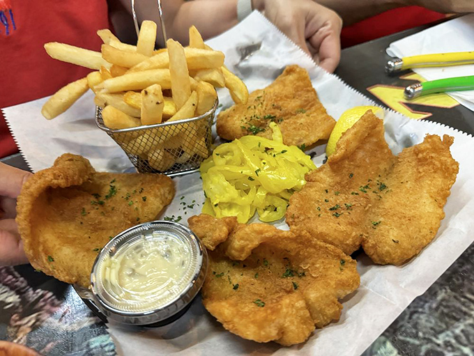 Golden-battered fish that's crispy enough to hear across the table, served with fries that could make a Frenchman weep with joy.