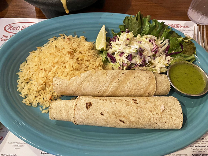 Simplicity meets perfection: fresh tortillas cradling their precious cargo, accompanied by perfectly seasoned rice and a salad that's more than an afterthought.