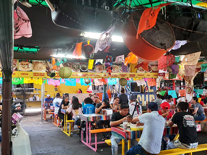Colorful chaos in the best possible way &ndash; this food court's vibrant decor matches the bold flavors coming from every direction.