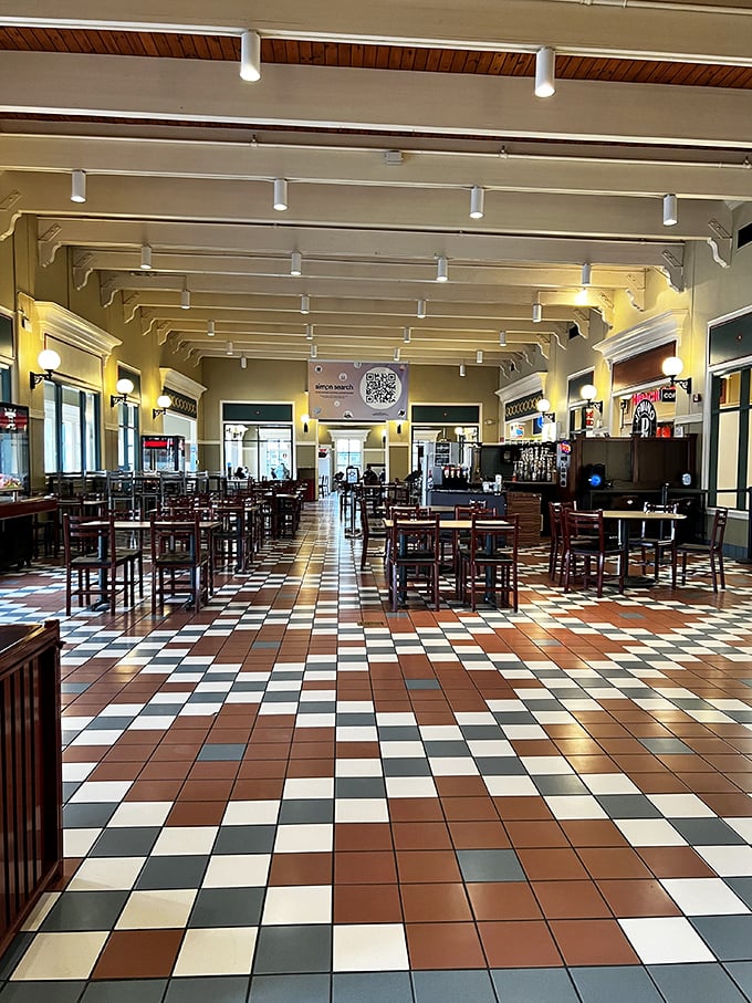 The food court's checkerboard floor and warm lighting create an oasis for weary shoppers. Refuel before round two!