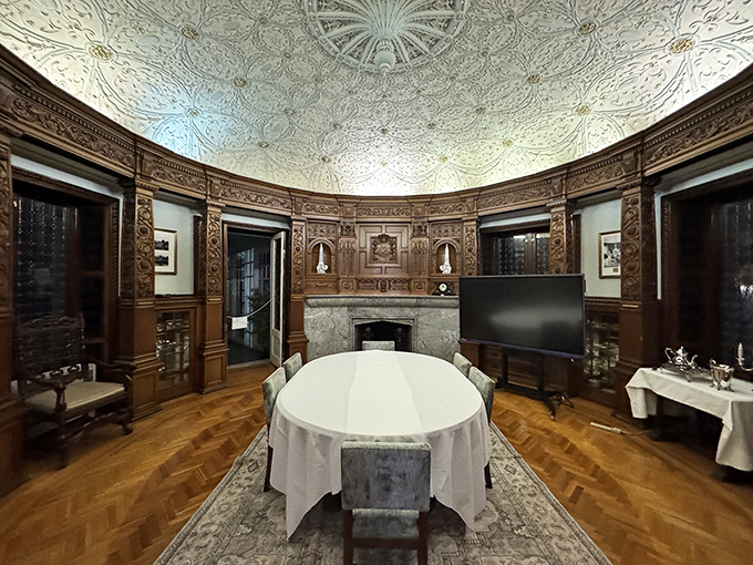 This formal dining room's ornate ceiling could make a pizza delivery feel like a state dinner. Napkin on lap, pinky extended.