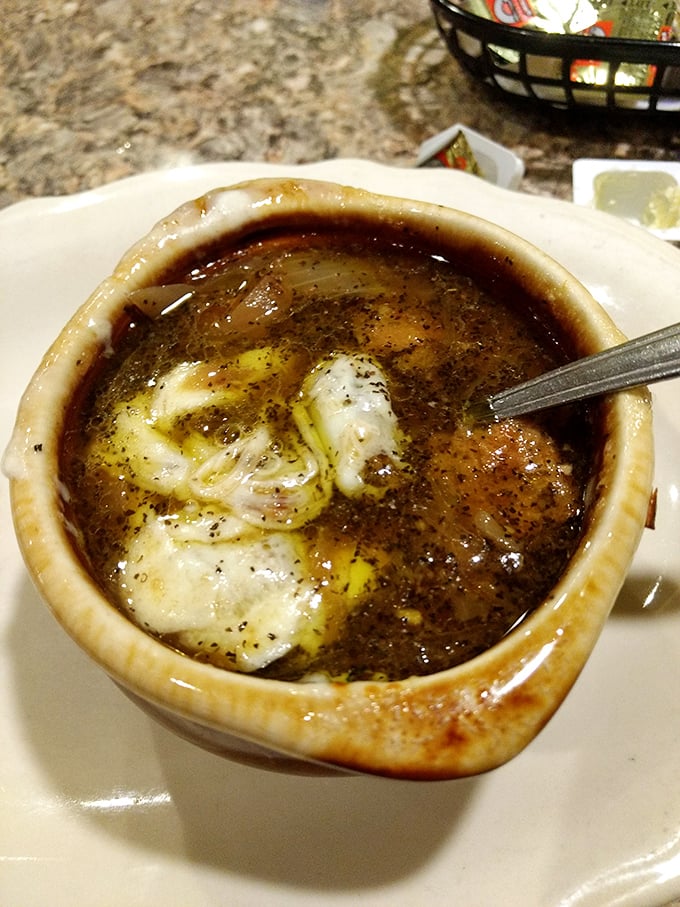 French onion soup that's worth the cheese pull photo op. That melty cap of broiled cheese is hiding a broth so rich it could buy a summer home.