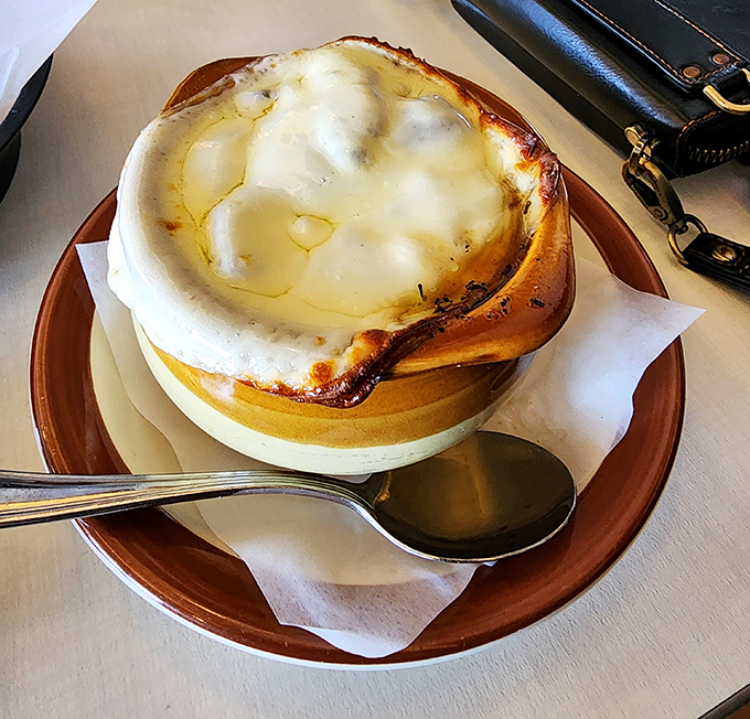 This isn't just soup - it's a cheese-crowned masterpiece that makes you wonder why French onion soup isn't an acceptable breakfast food.