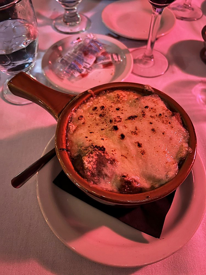 French onion soup that's wearing a blanket of melted cheese like it's the coziest thing in the world. Comfort in a crock that's worth every potential cheese-pull mishap.