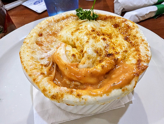 Bubbling cheese creates the perfect seal over this French onion soup, like nature's perfect lid designed to trap maximum flavor until your spoon breaks through.