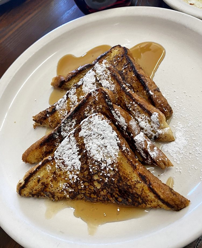 French toast dusted with powdered sugar and swimming in maple syrup&mdash;proof that bread can indeed achieve its highest purpose in life.