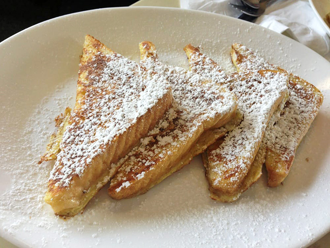 French toast that's achieved celebrity status &ndash; powdered sugar dusted triangles that make you wonder if dessert for breakfast is actually the smartest idea ever.