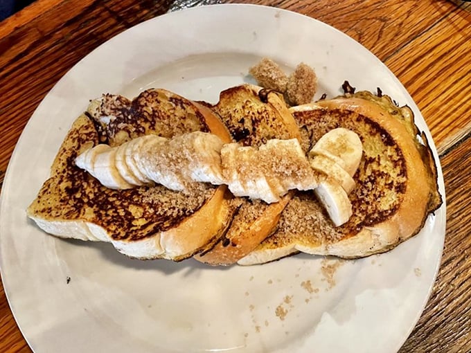 French toast that would make a Parisian jealous! Topped with fresh bananas and a dusting of powdered sugar, it's breakfast masquerading as dessert.