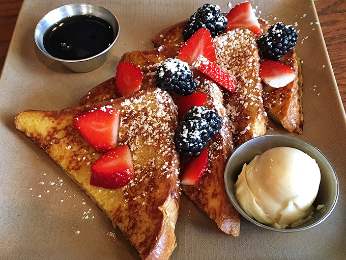 French toast that's crossed the line from breakfast to dessert, with berries and cream playing supporting roles in this morning theater of deliciousness.