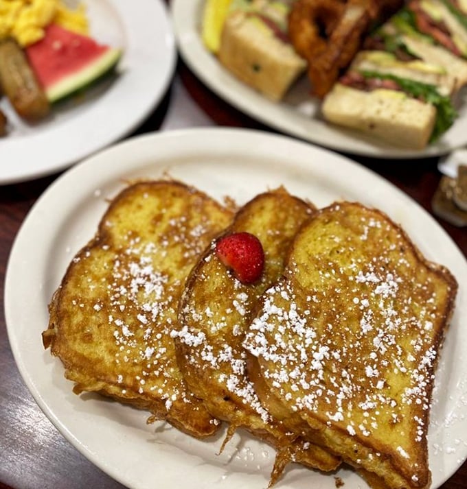 French toast that's golden, fluffy, and dusted with enough powdered sugar to make your inner child do cartwheels.