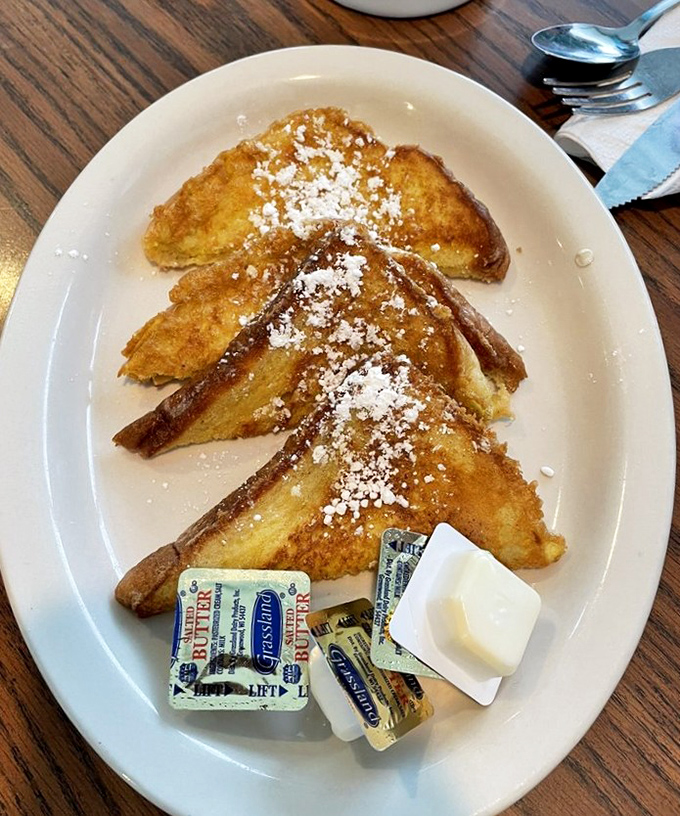 French toast that's achieved that magical golden-brown perfection, dusted with powdered sugar like the first perfect snowfall of winter.