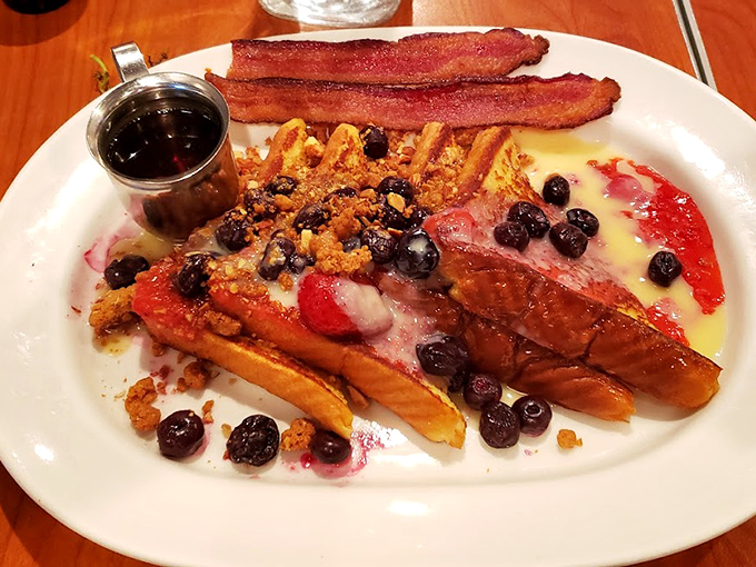 French toast that makes you question every other breakfast you've ever had. Those berries aren't just garnish&mdash;they're little flavor bombs of pure joy.