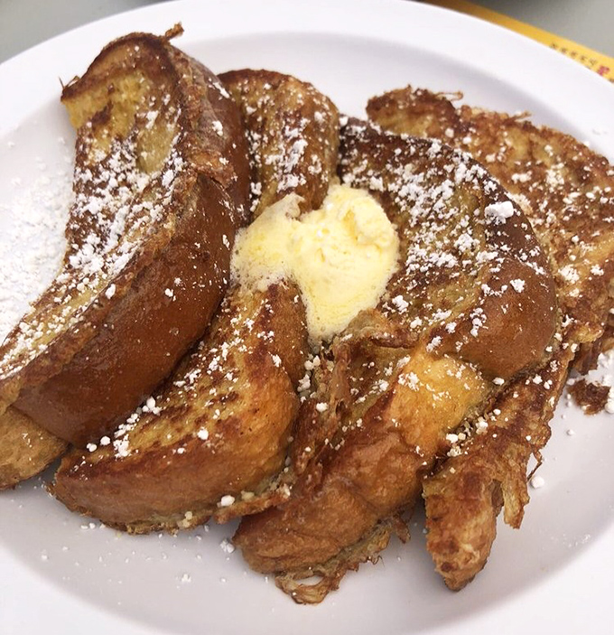 French toast that makes you question every other breakfast you've ever had. That melting butter pat is basically performing a swan dive into deliciousness.