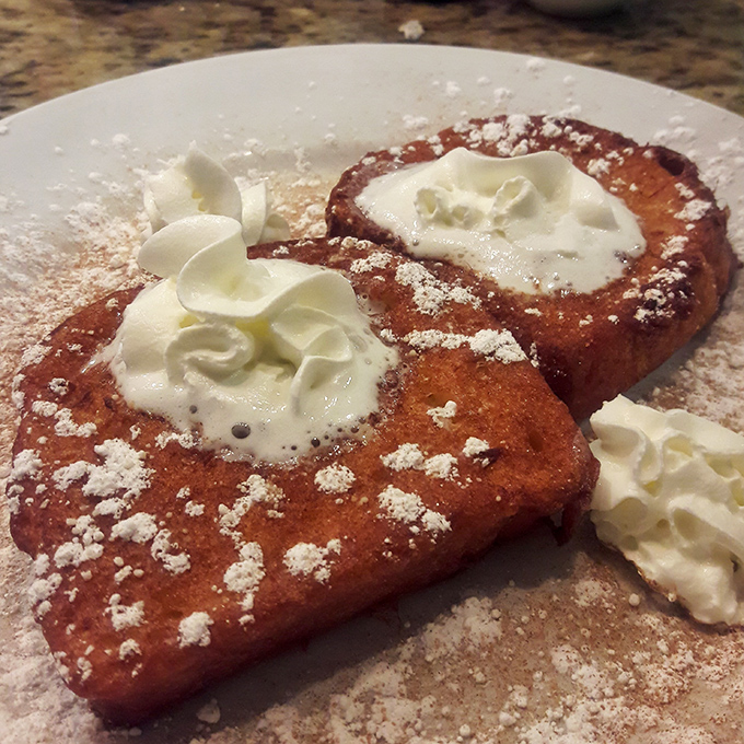 French toast that makes you question all other French toast you've ever had. Those dollops of whipped cream aren't just garnish&mdash;they're little clouds of joy.