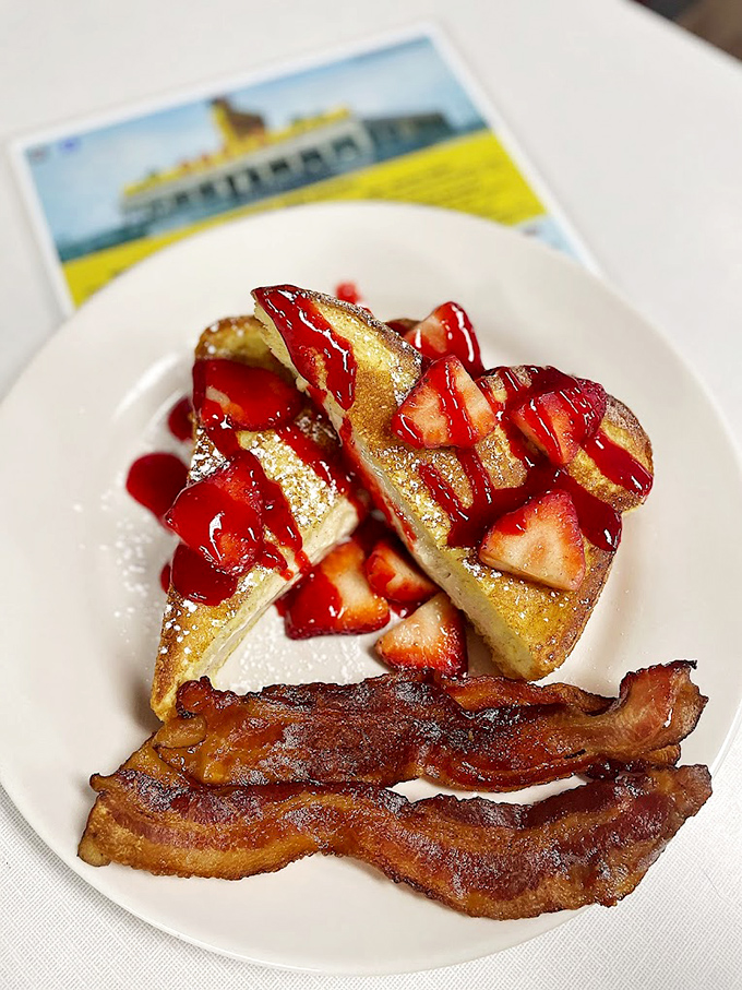 French toast that doesn't just satisfy hunger but creates memories, topped with strawberries that actually taste like strawberries.