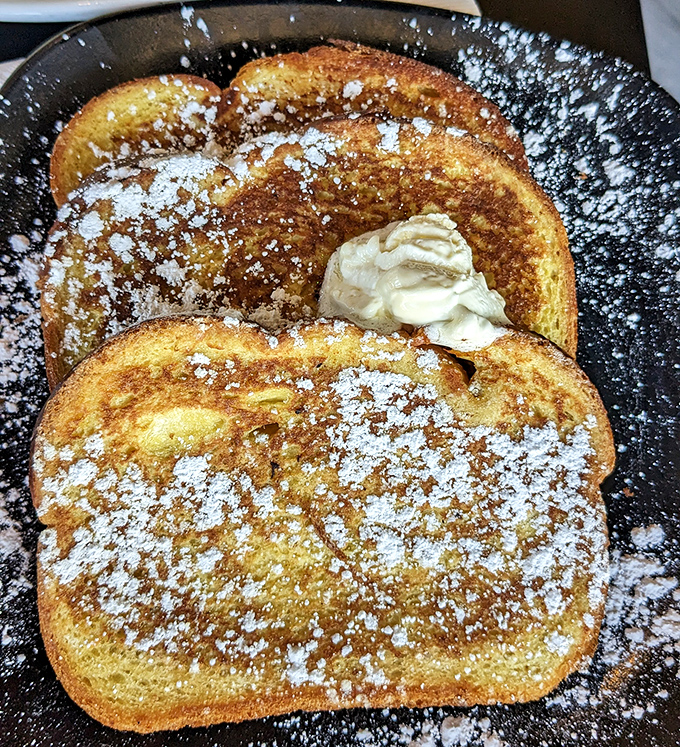Golden-brown French toast dusted with powdered sugar &ndash; proof that bread can achieve greatness with just a little egg bath.