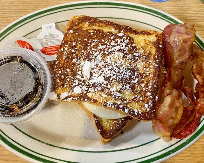 French toast that's dressed for success with a dusting of powdered sugar and bacon sidekick. Breakfast doesn't get more photogenic than this.