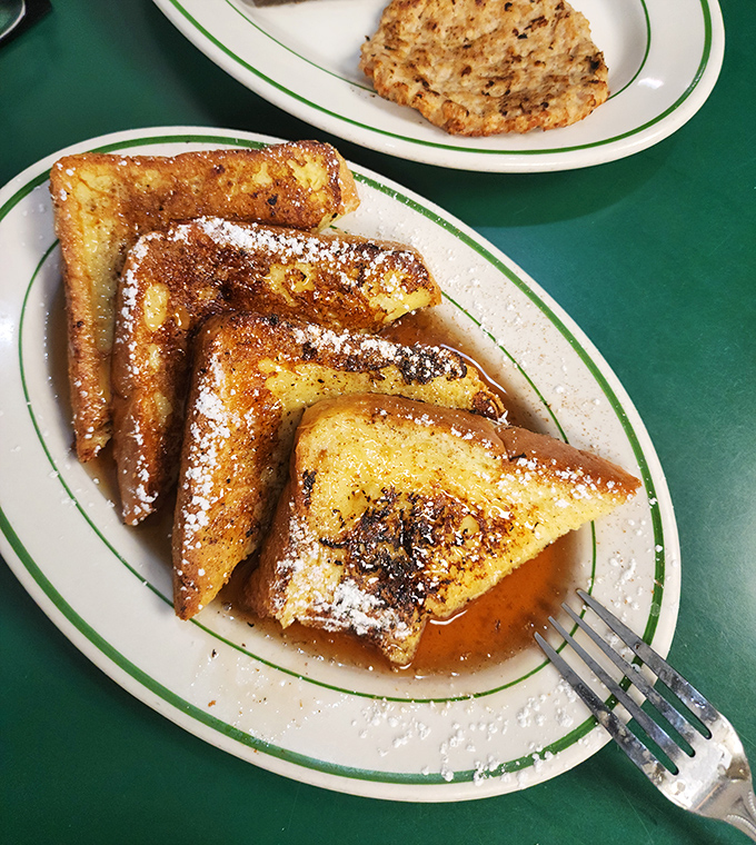French toast dusted with powdered sugar and swimming in syrup. The breakfast equivalent of a warm hug from your grandmother.
