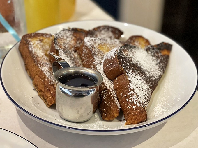 French toast that's dressed for success&mdash;powdered sugar "snow" falling on golden-brown landscape with a silver pot of syrup standing by for the finishing touch.