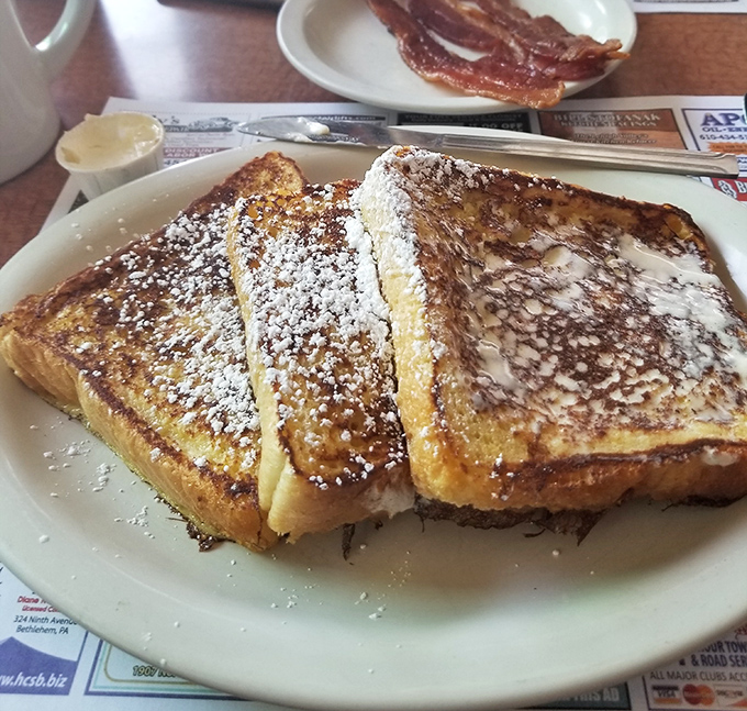 French toast that makes you question why you ever settled for lesser breakfast options. Dusted with powdered sugar like fresh snow on a delicious mountain range.