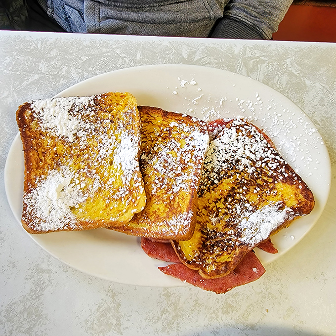 French toast that would make actual French people jealous, dusted with powdered sugar and served with a side of nostalgia.