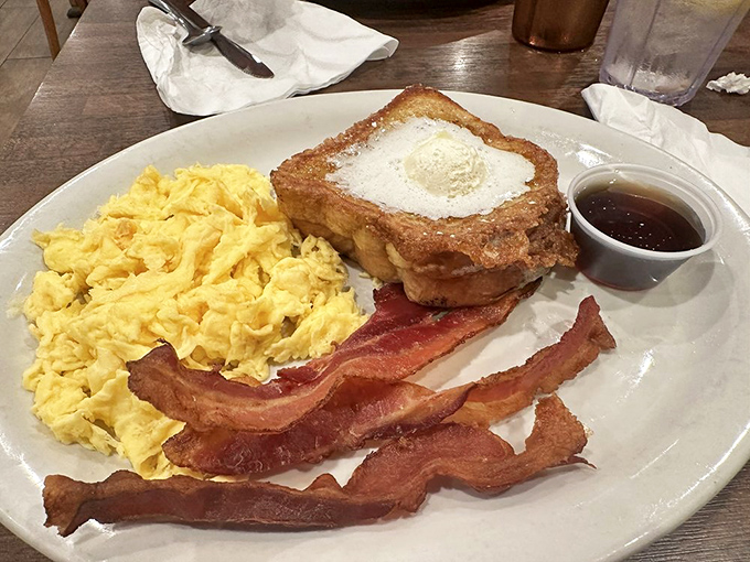 French toast that makes ordinary bread weep with jealousy. The scrambled eggs look like fluffy yellow clouds on a breakfast paradise island.