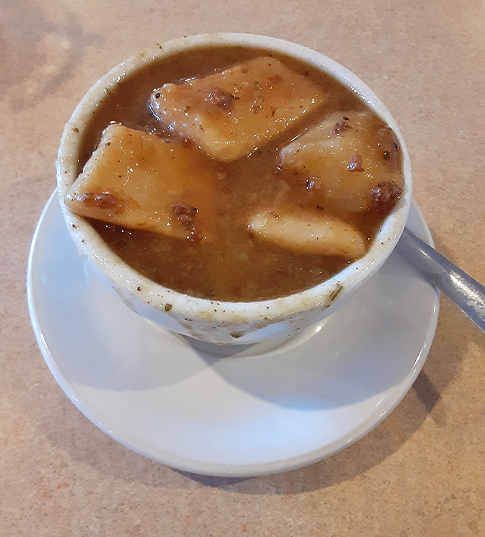 French onion soup arrives bubbling hot, with cheese stretching like edible heartstrings across the bowl's rim.