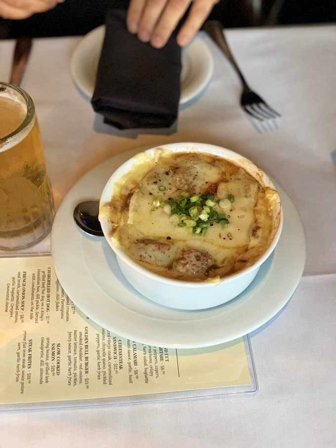French onion soup that's worth the inevitable cheese pull photo op – a bubbling cauldron of comfort topped with golden, gooey goodness.