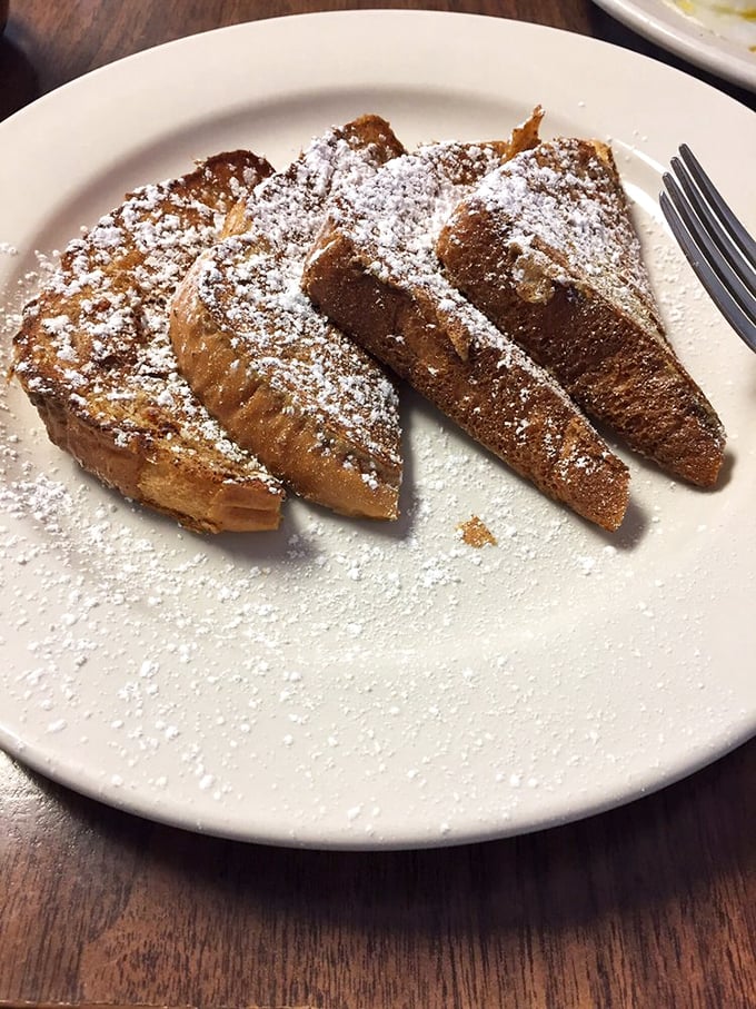 French toast dusted with powdered sugar like fresh snow on a winter morning. Breakfast or dessert? The line deliciously blurs.