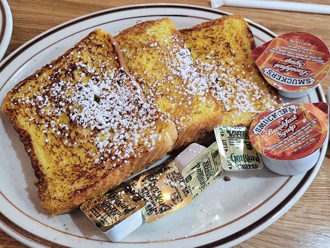 Golden French toast dusted with powdered sugar like fresh snow on a Pennsylvania morning &ndash; breakfast poetry on a plate.