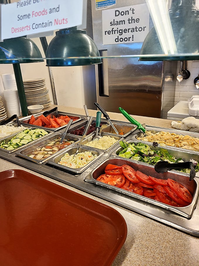 The salad bar offers a moment of virtuous decision-making before the glorious indulgence that follows. Those tomatoes look fresh enough to have been picked this morning.