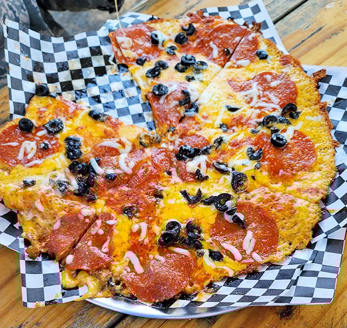 Pizza reimagined &ndash; crispy cheese forms the foundation for this saucy, olive-studded masterpiece that defies conventional pizza boundaries.