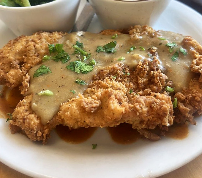 Comfort food elevated: golden-fried chicken beneath a blanket of savory gravy. Southern grandmothers everywhere would give this their solemn nod of approval.