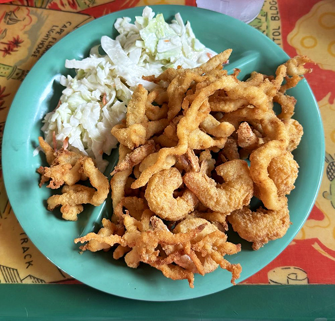 Golden-fried perfection alongside cool, crisp coleslaw. These fried clams aren't just appetizers&mdash;they're little crunchy treasures from the sea.