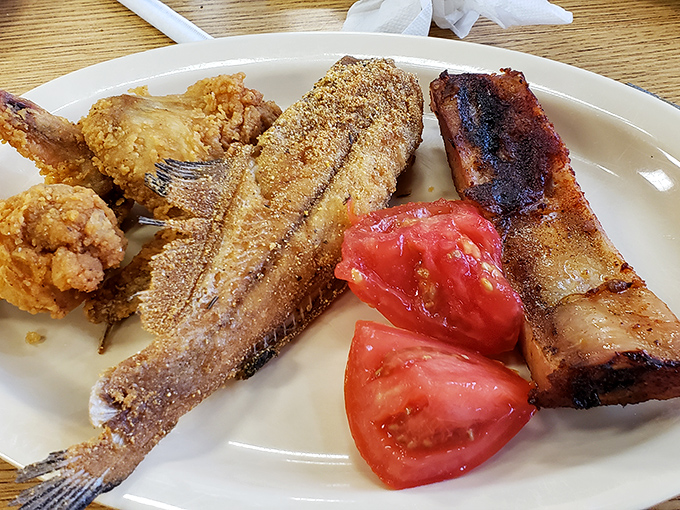 A plate that answers the eternal question: "Why choose?" Crispy fried fish, smoky ribs, and fresh tomatoes create the perfect Southern harmony.