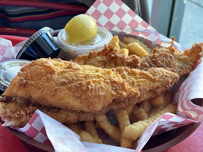 Golden-fried haddock that shatters at first bite, revealing flaky white fish within. The lemon wedge isn't just garnish&mdash;it's an essential supporting character.
