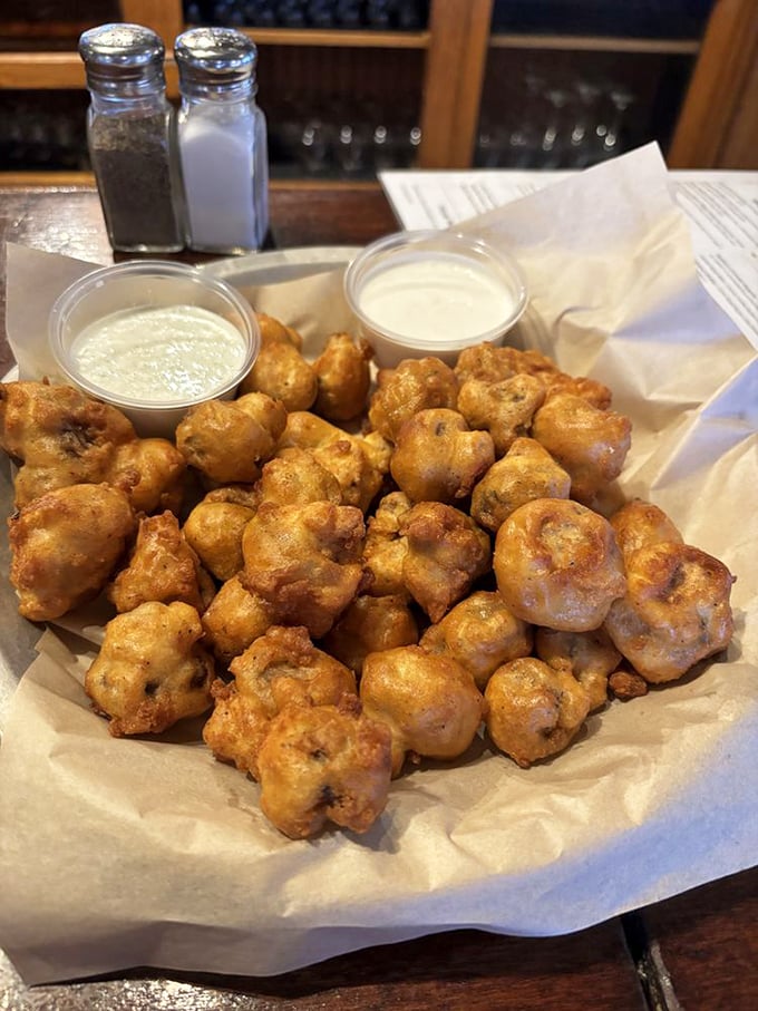 Golden-fried mushroom bites that crunch like autumn leaves, with dipping sauces standing by for their moment of glory.