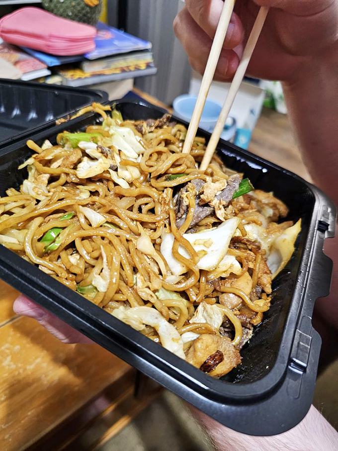 Noodles dancing with vegetables and meat in a symphony of umami. Fork or chopsticks? The only wrong choice is not ordering it.